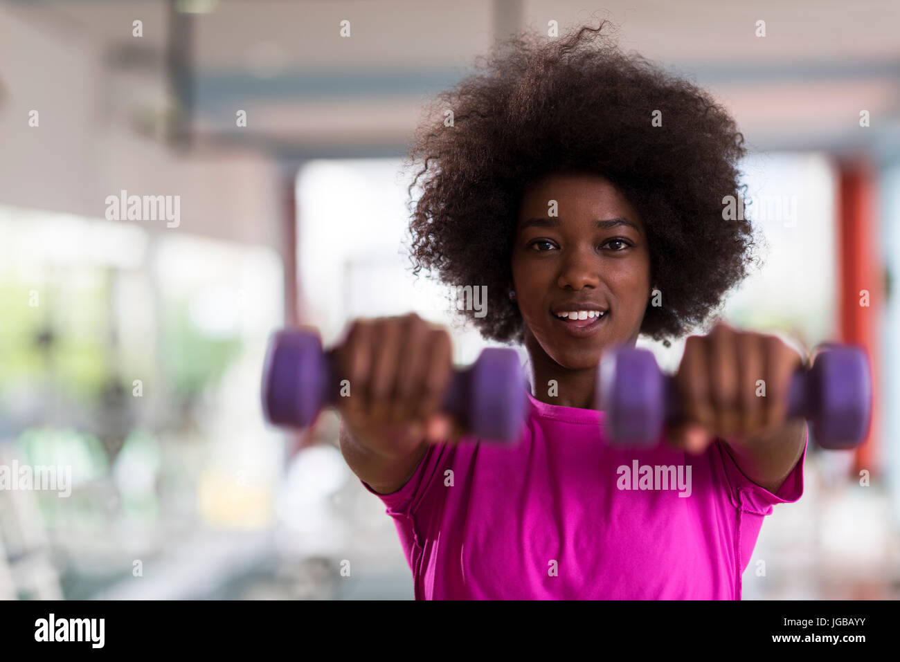 happy healthy african american woman working out in a crossfit gym on ...