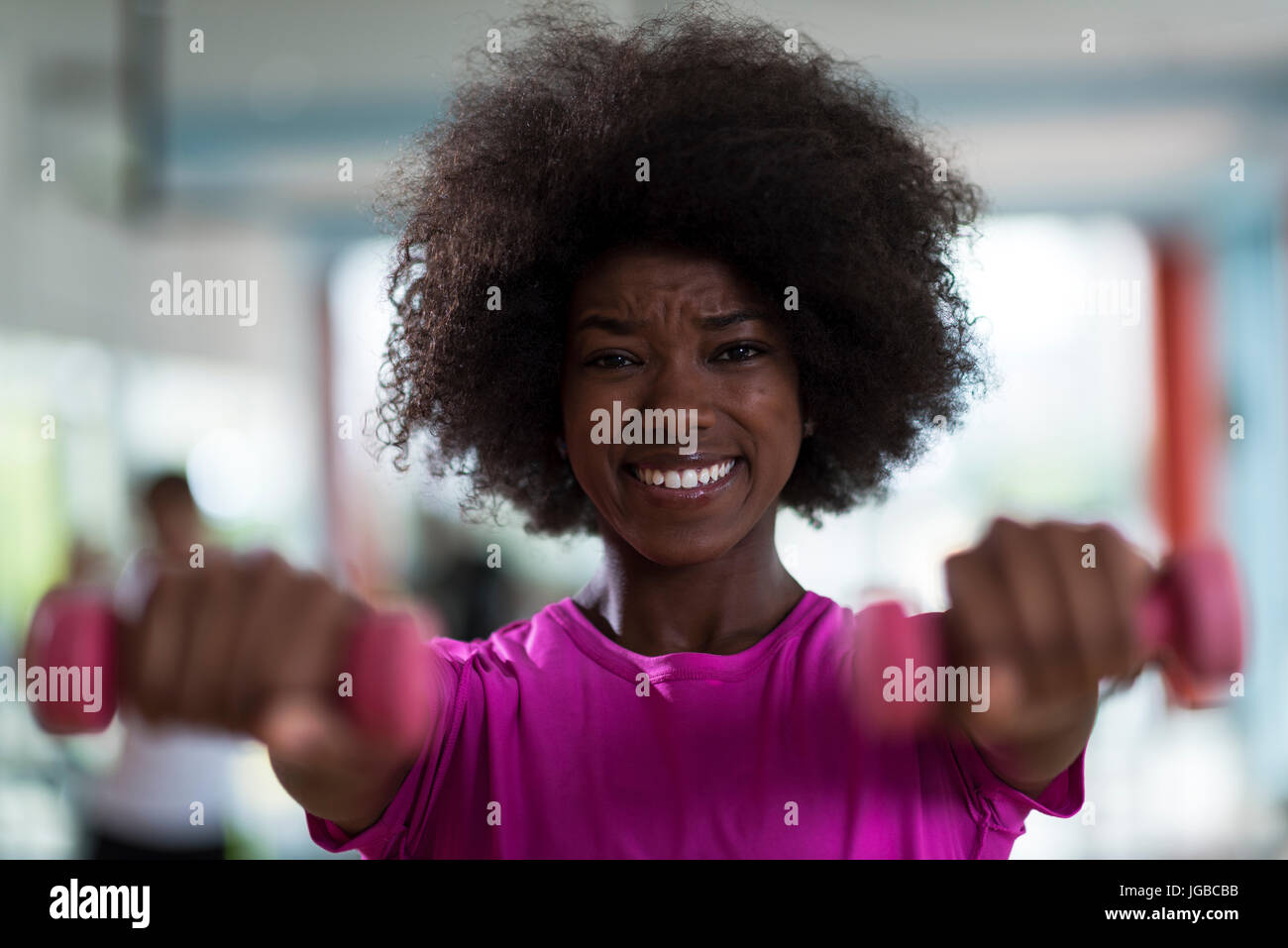 happy healthy african american woman working out in a crossfit gym on ...