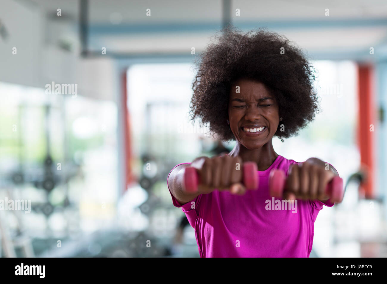 happy healthy african american woman working out in a crossfit gym on ...