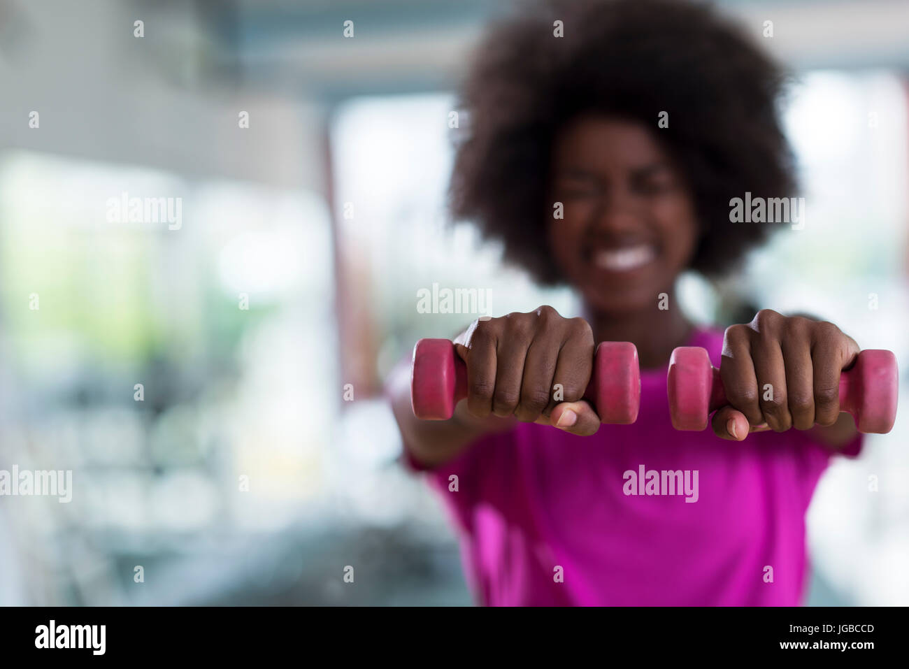 happy healthy african american woman working out in a crossfit gym on ...