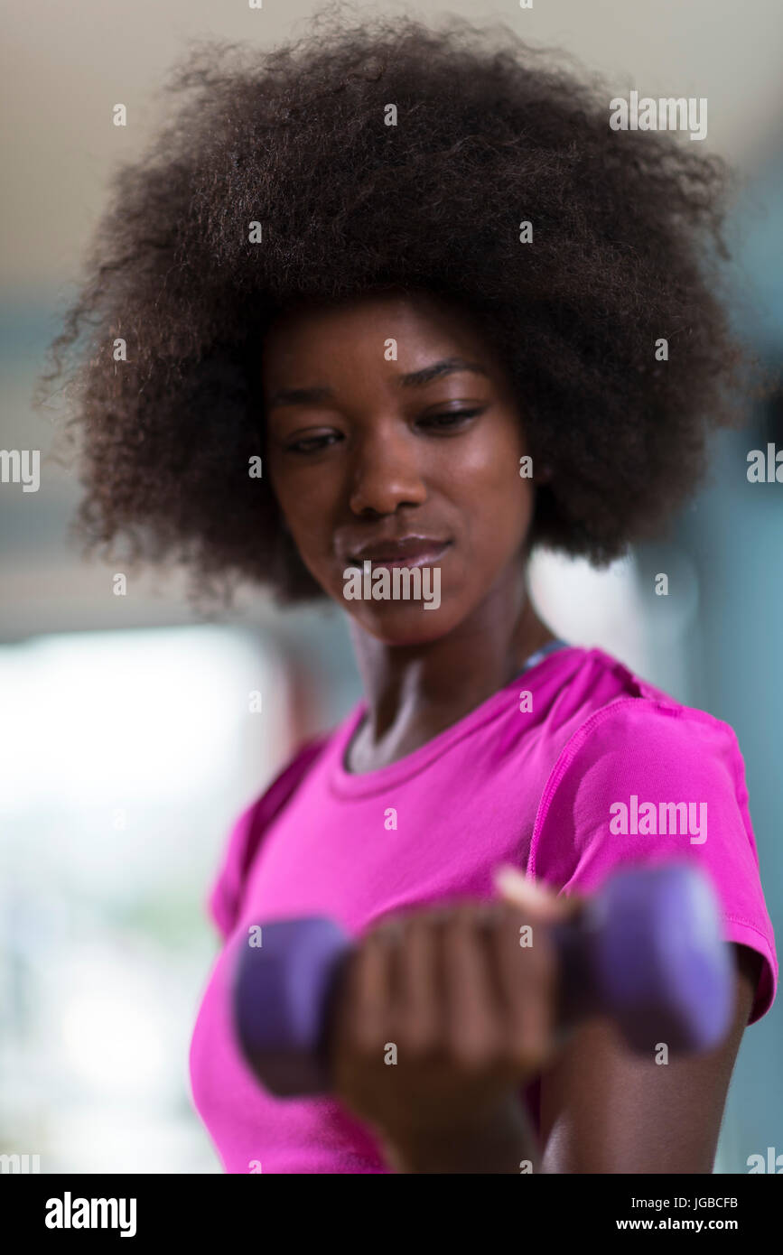 happy healthy african american woman working out in a crossfit gym on ...