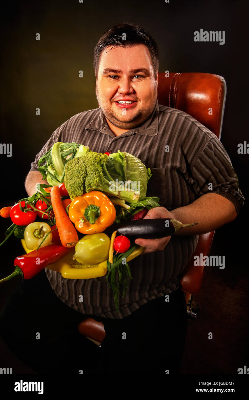 Diet fat man eating healthy food . Healthy breakfast with vegetables ...