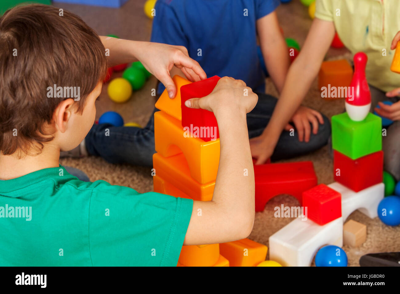 Children building blocks in kindergarten. Group kids playing toy floor ...