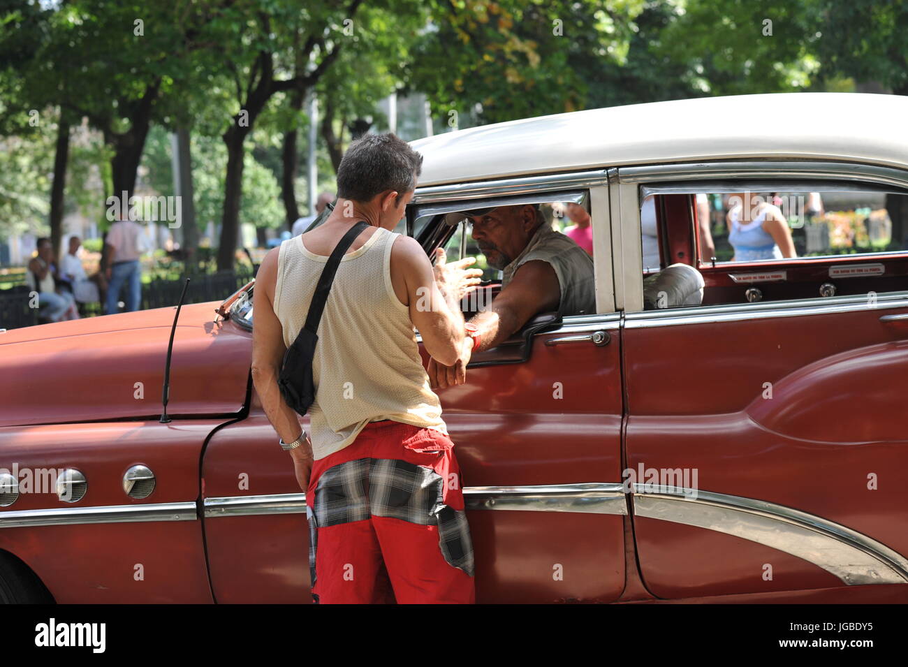 Classic American taxi driver being paid, Havana Cuba Stock Photo - Alamy