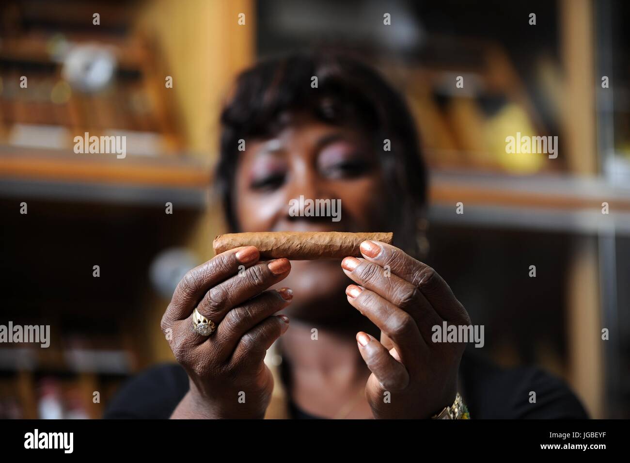 A black woman rolling cuban style cigars in a traditional, old ...