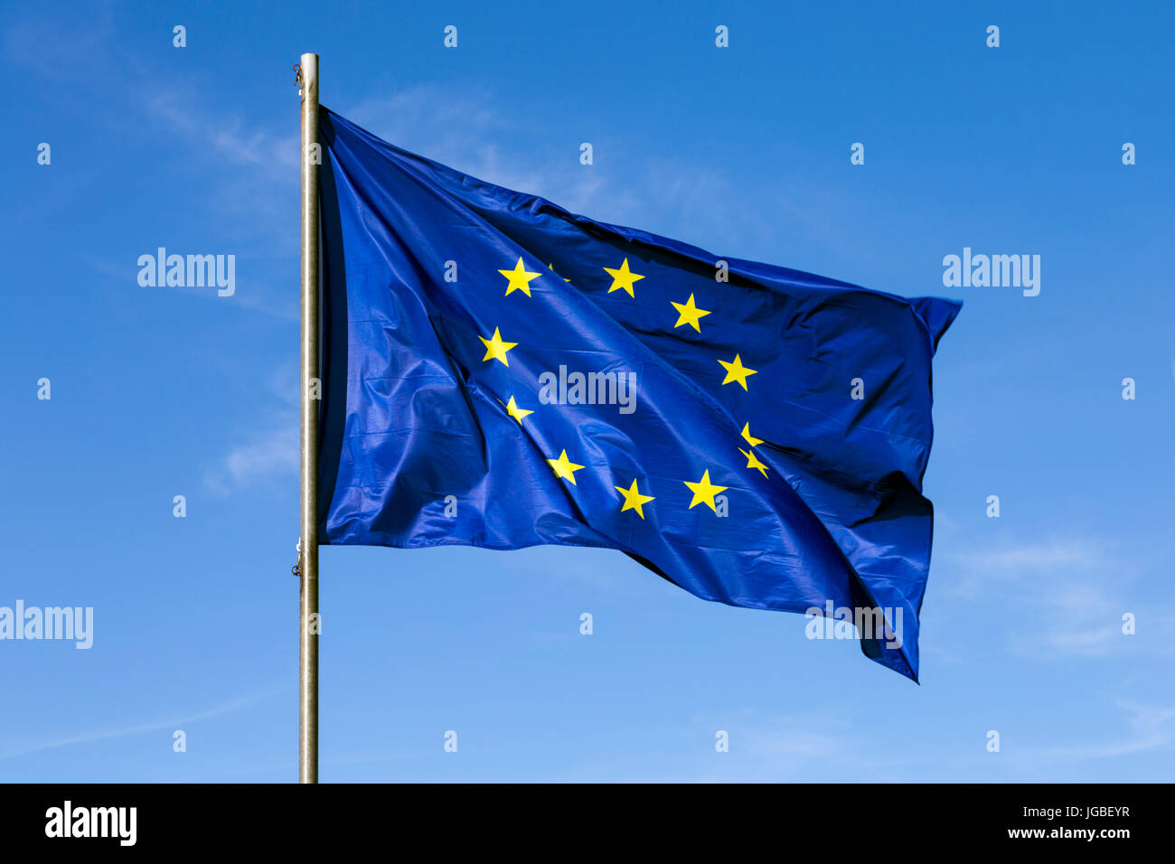 European Union flag against a blue sky background Stock Photo - Alamy