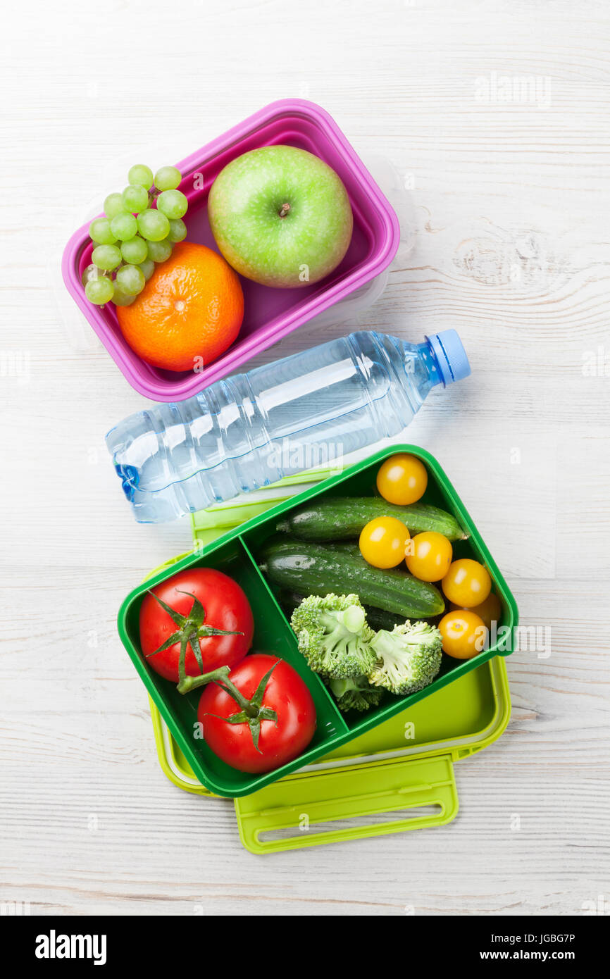 Lunch box with vegetable and fruits on wooden table. Top view Stock ...