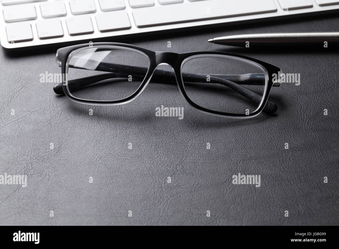 Office desk with computer, glasses and supplies. With space for your ...