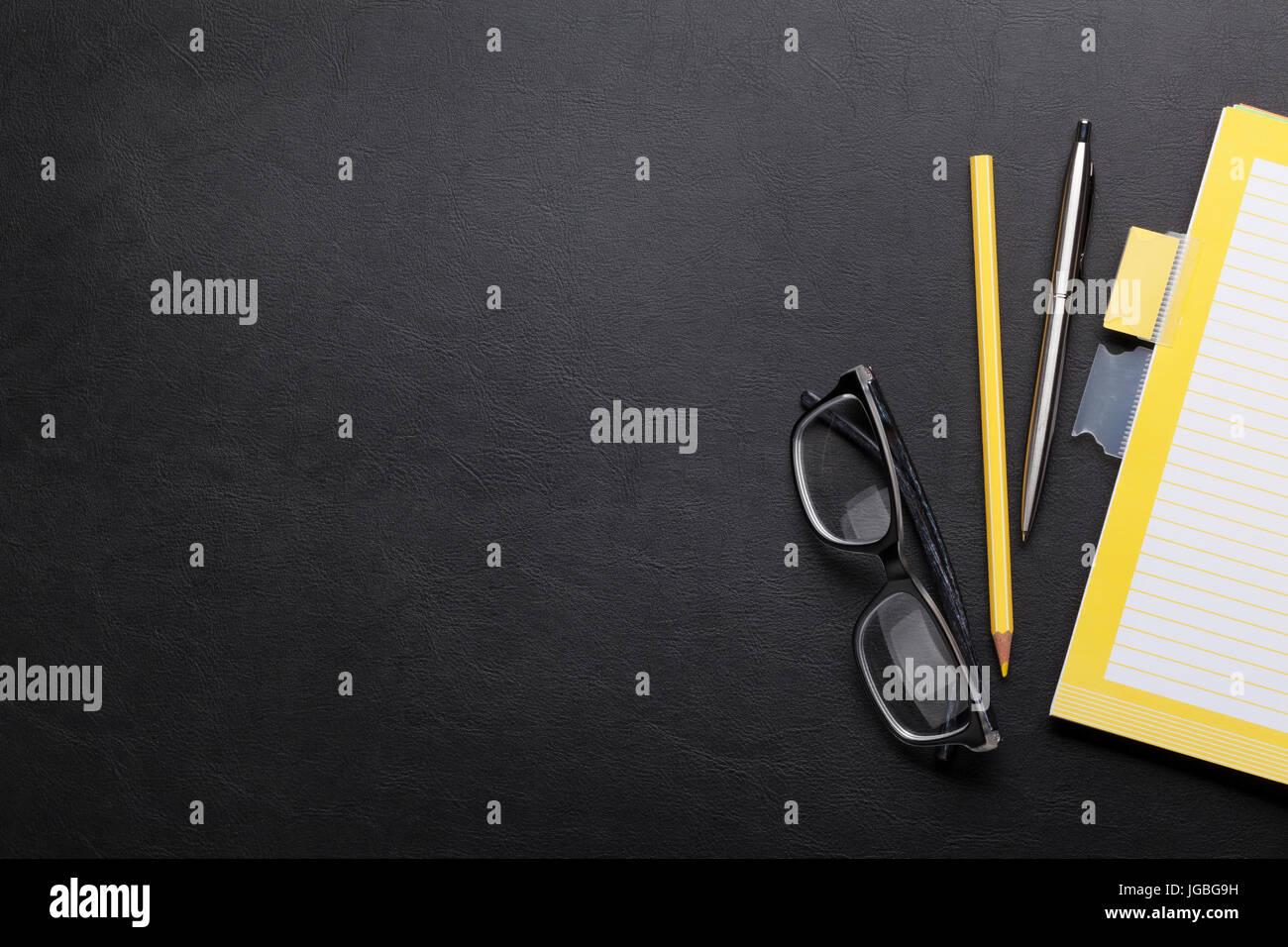 Office desk with notepad and supplies. Top view with space for your ...