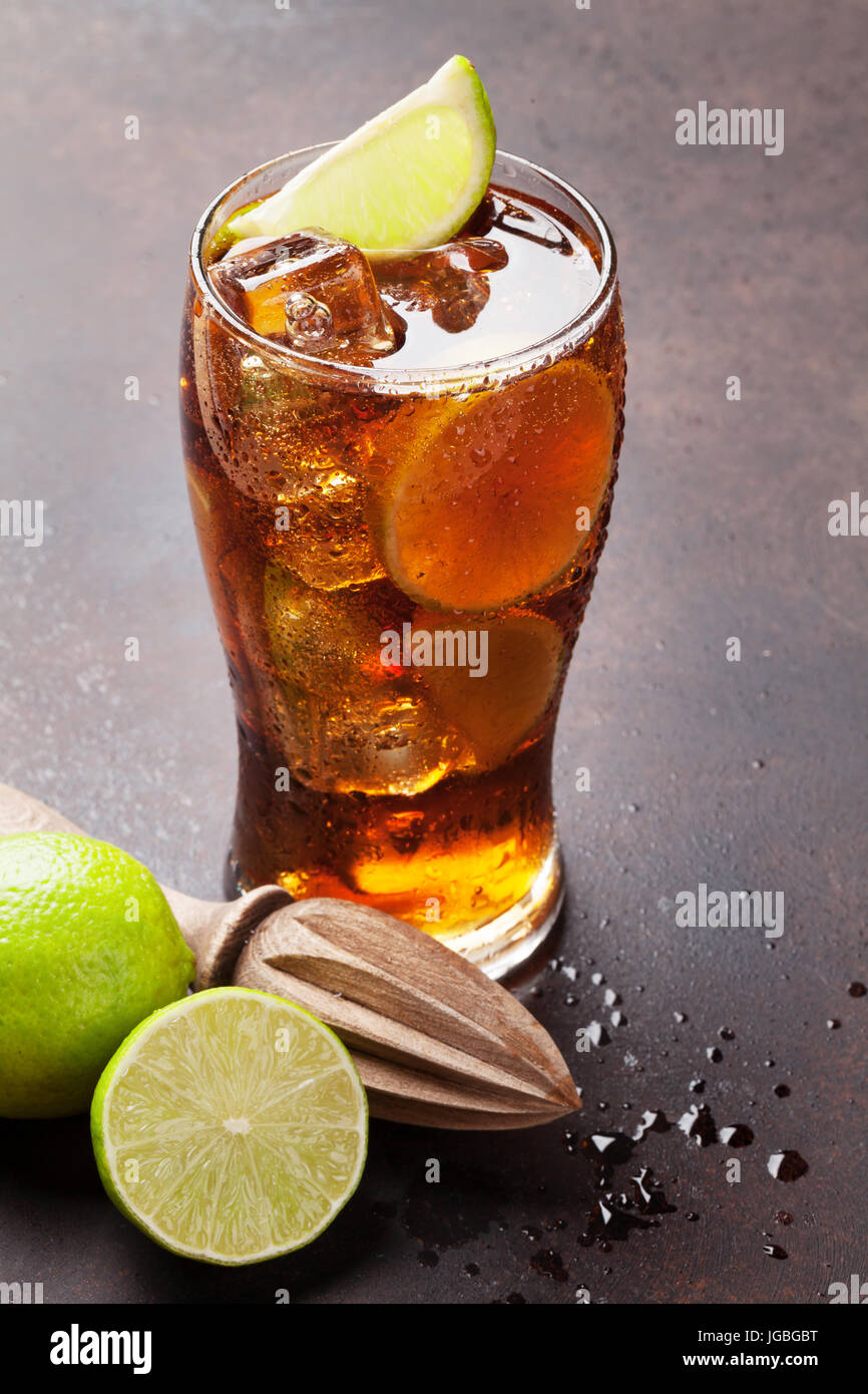 Cuba libre cocktail glass on stone table Stock Photo - Alamy