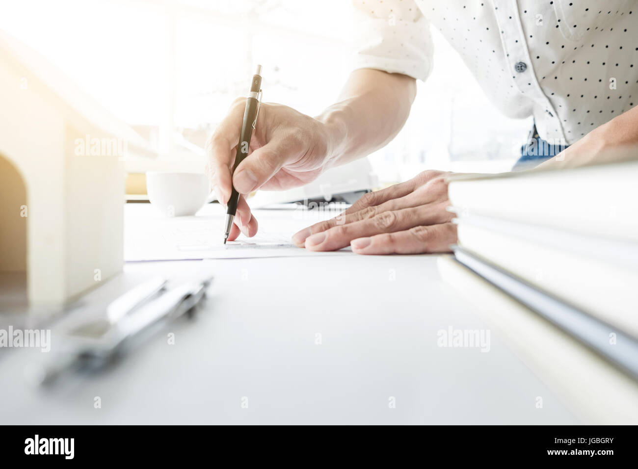 Close-up Of Person's engineer Hand Drawing Plan On Blue Print with ...