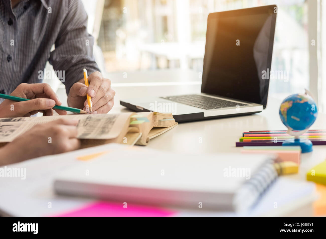 Young woman and man studying for a test/ an exam. Tutor books with ...