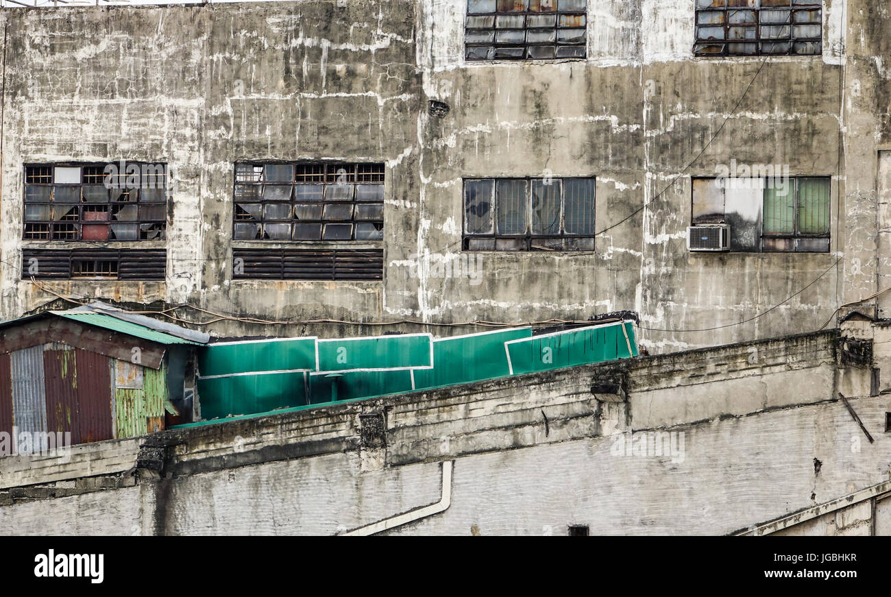 Aged brick wall with cracks and scuffs in slum region of Manila ...