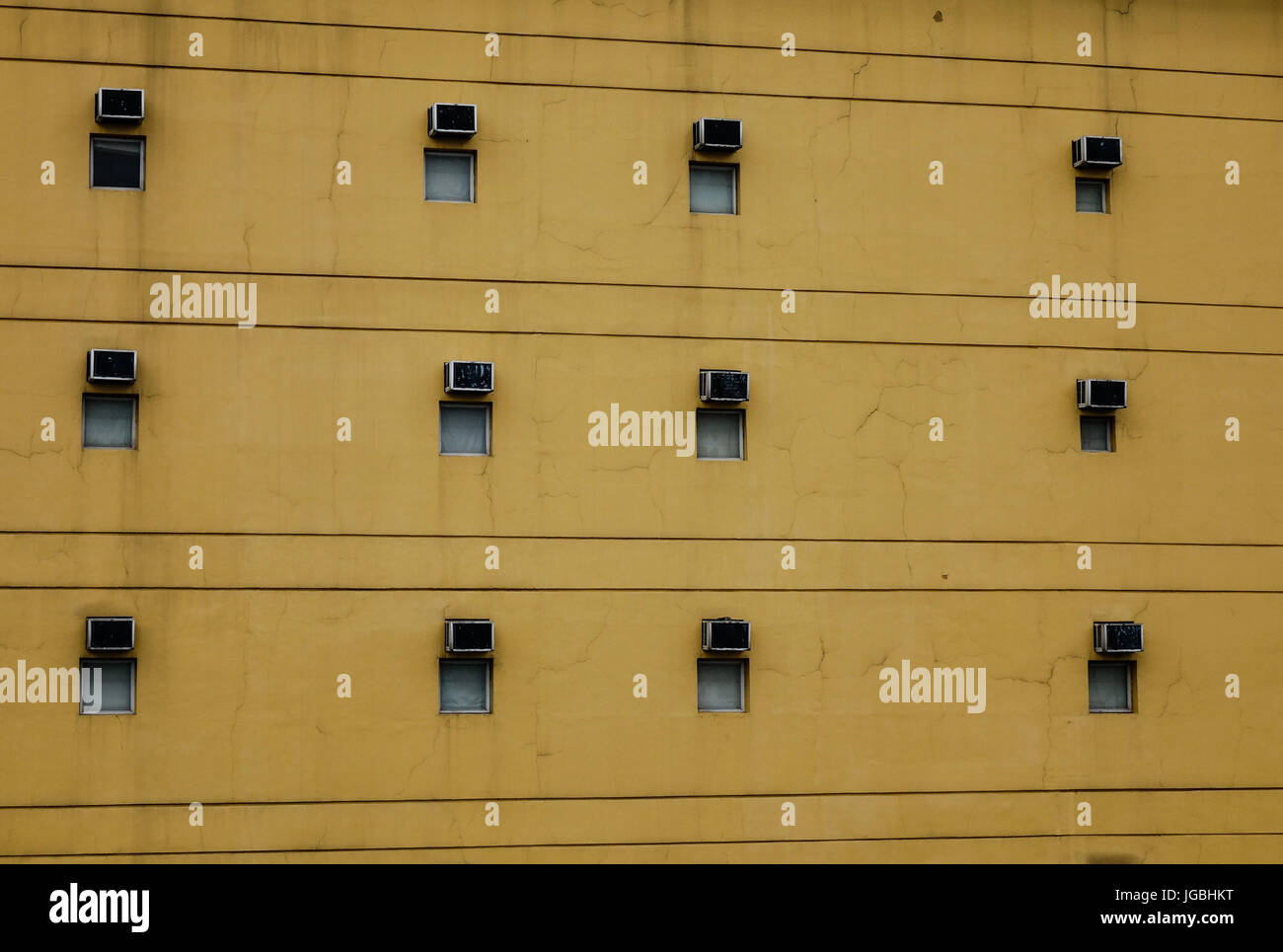Aged brick wall with many windows in slum region of Manila, Philippines ...