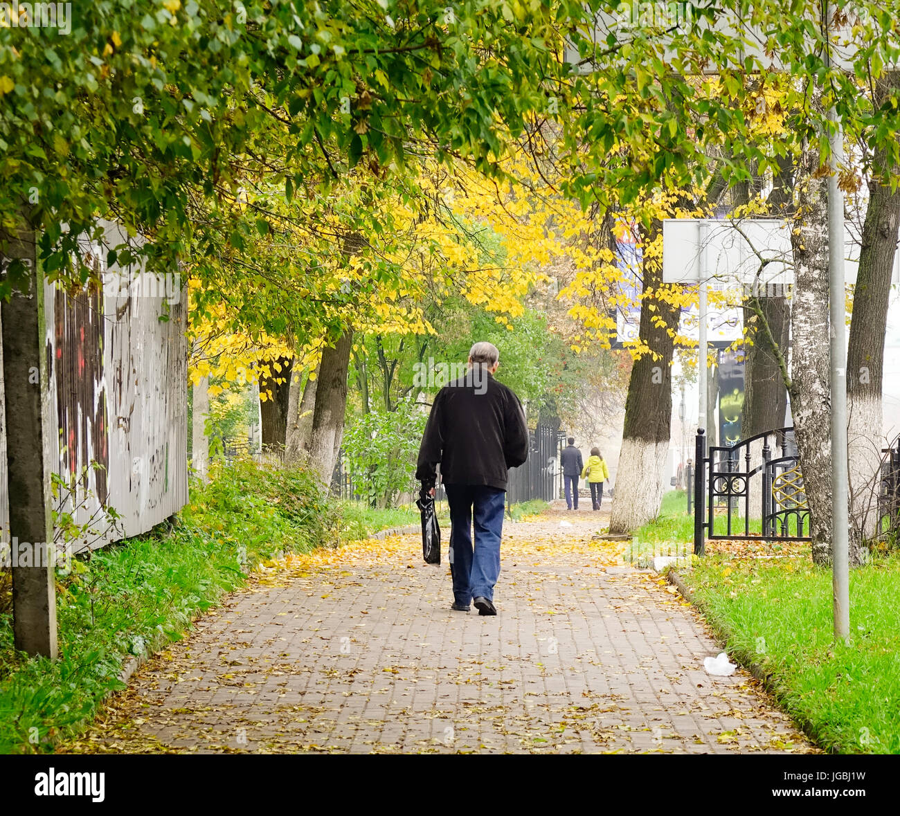 A man walking on street in autumn Stock Photo - Alamy