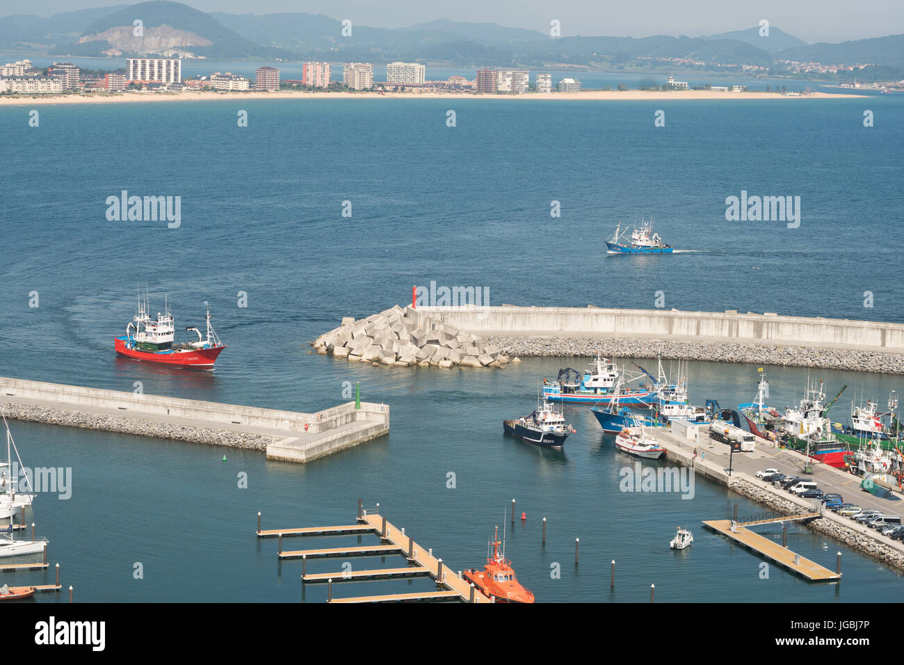 Fishing boats negotiating harbour mouth, Laredo, Cantabria, Spain Stock ...