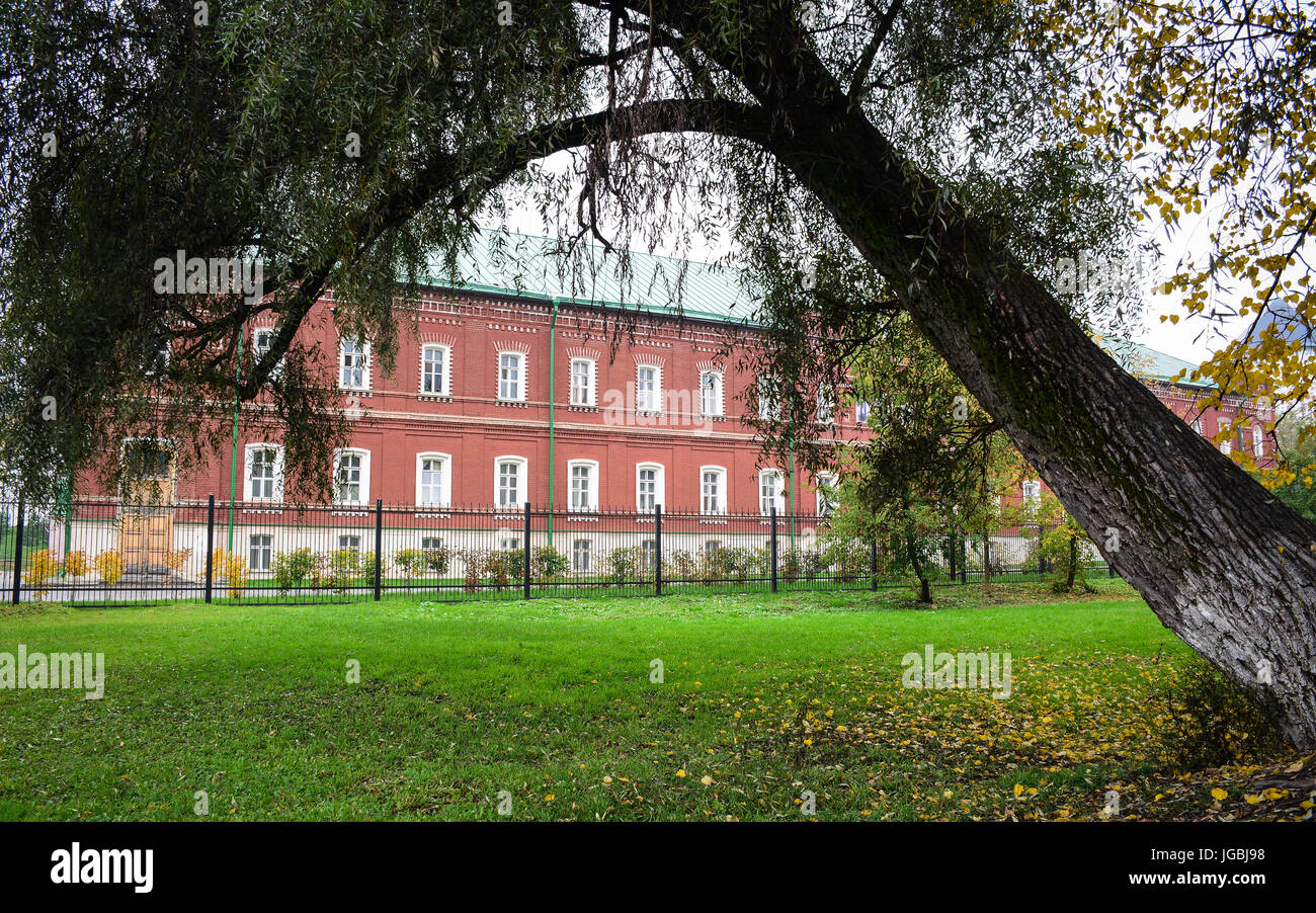 Ancient brick monastery with a big tree at garden in Sergiev Posad ...