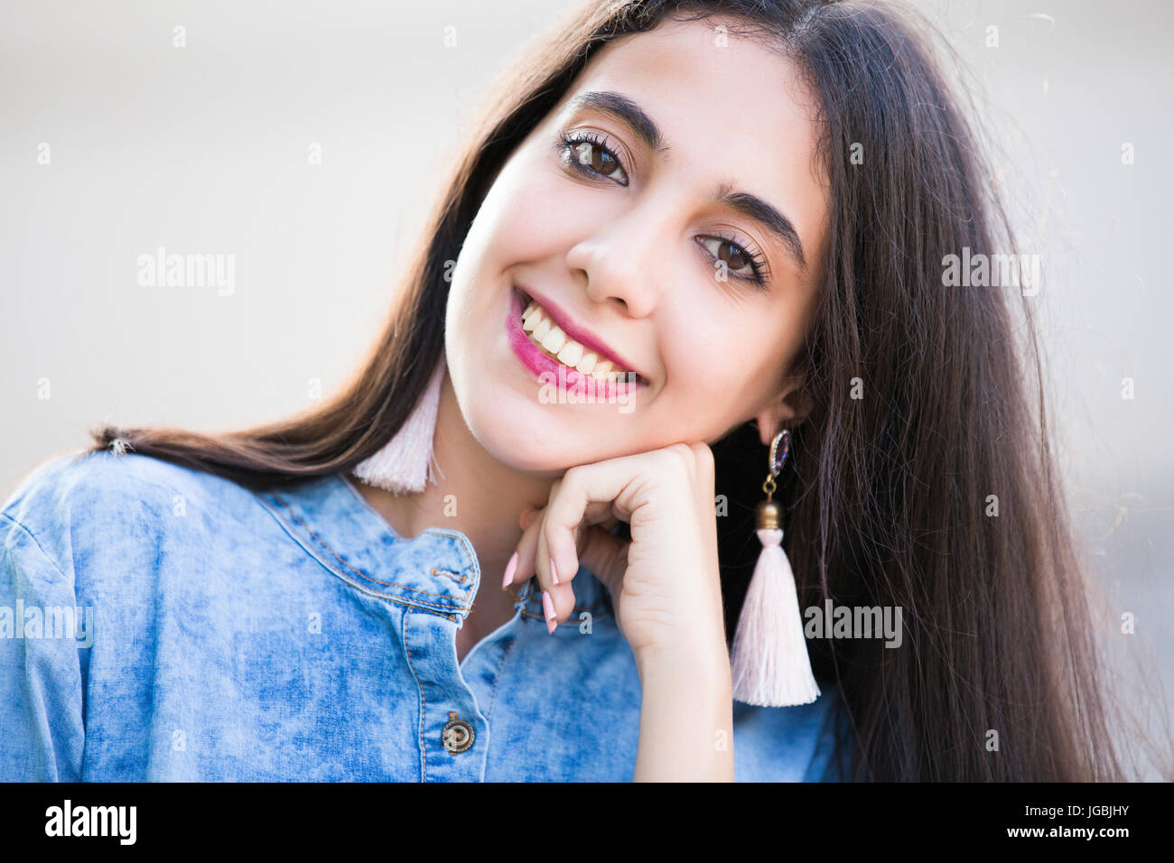 Close up portrait of a beautiful young Lebanese woman hand touching ...