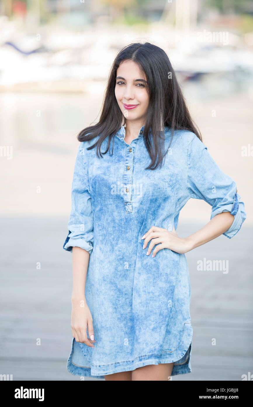 Beautiful young Lebanese woman standing outdoors hand on hip smiling ...