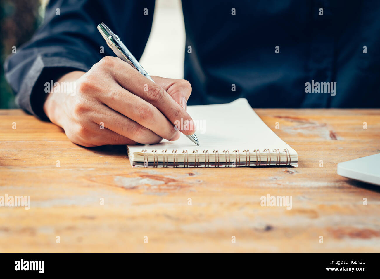Hand business man writing notebook on wood table in coffee shop Stock ...