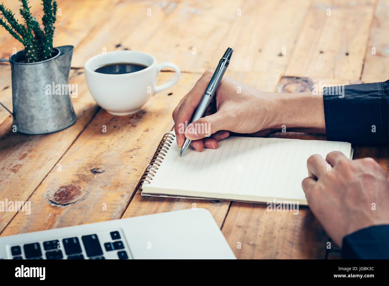 Hand business man writing notebook on wood table in coffee shop Stock ...