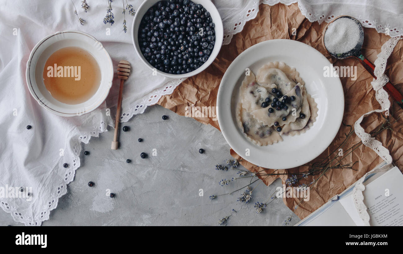 Above view of the rustic composition of the cup of tea, plate full of ...