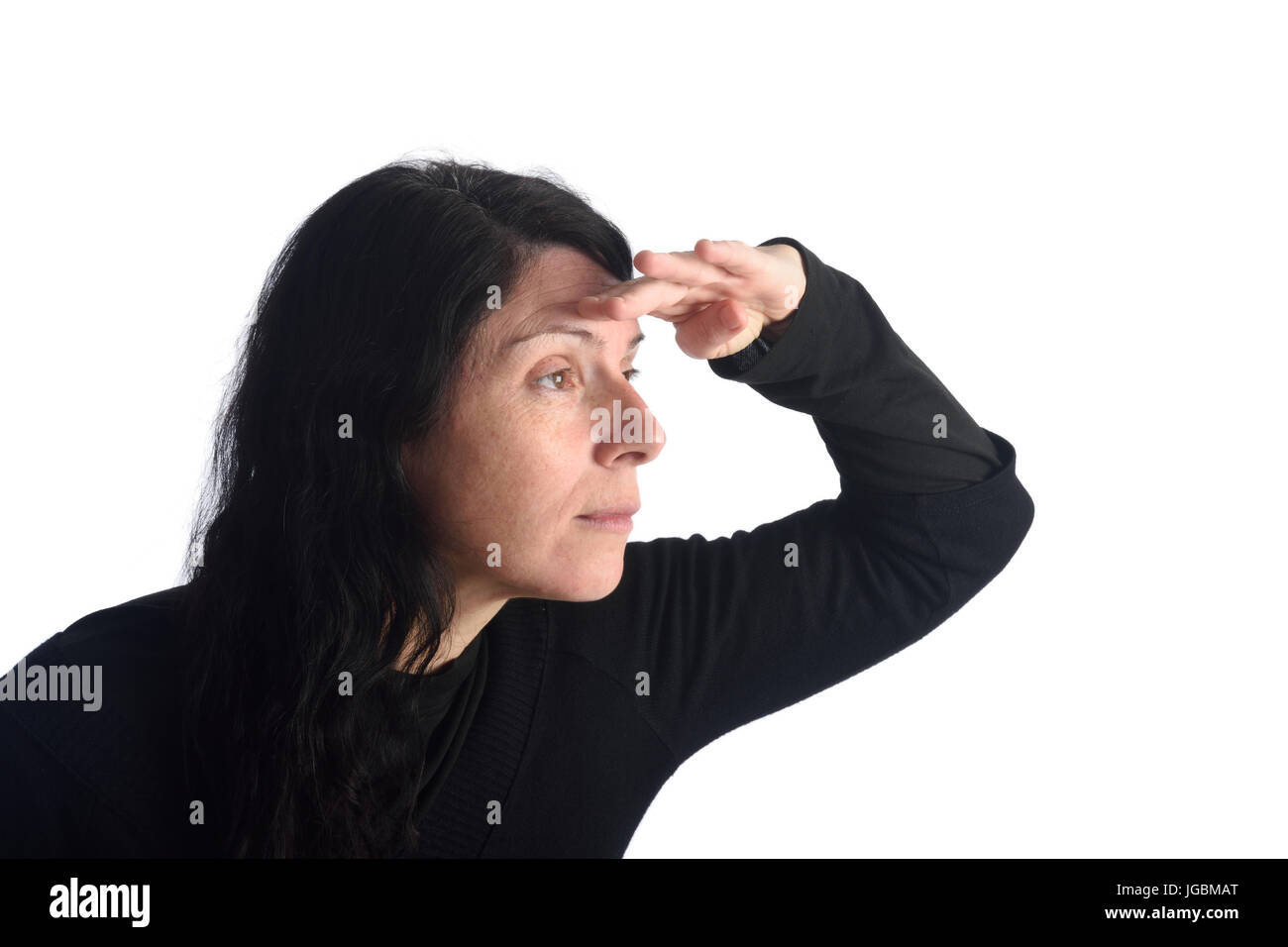 Woman looking with hand on forehead Stock Photo - Alamy