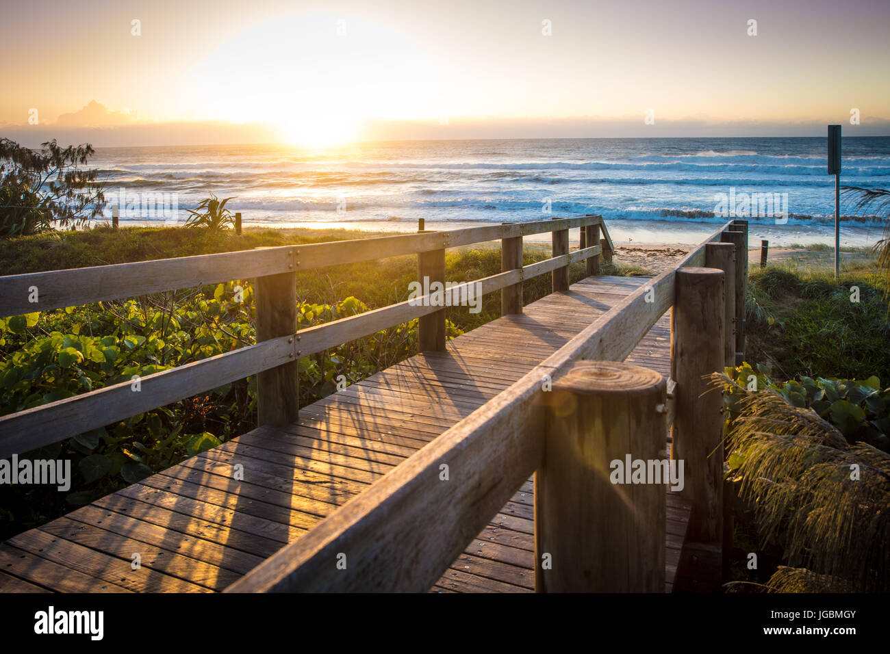 A wooden boardwalk leading to the ocean Stock Photo - Alamy