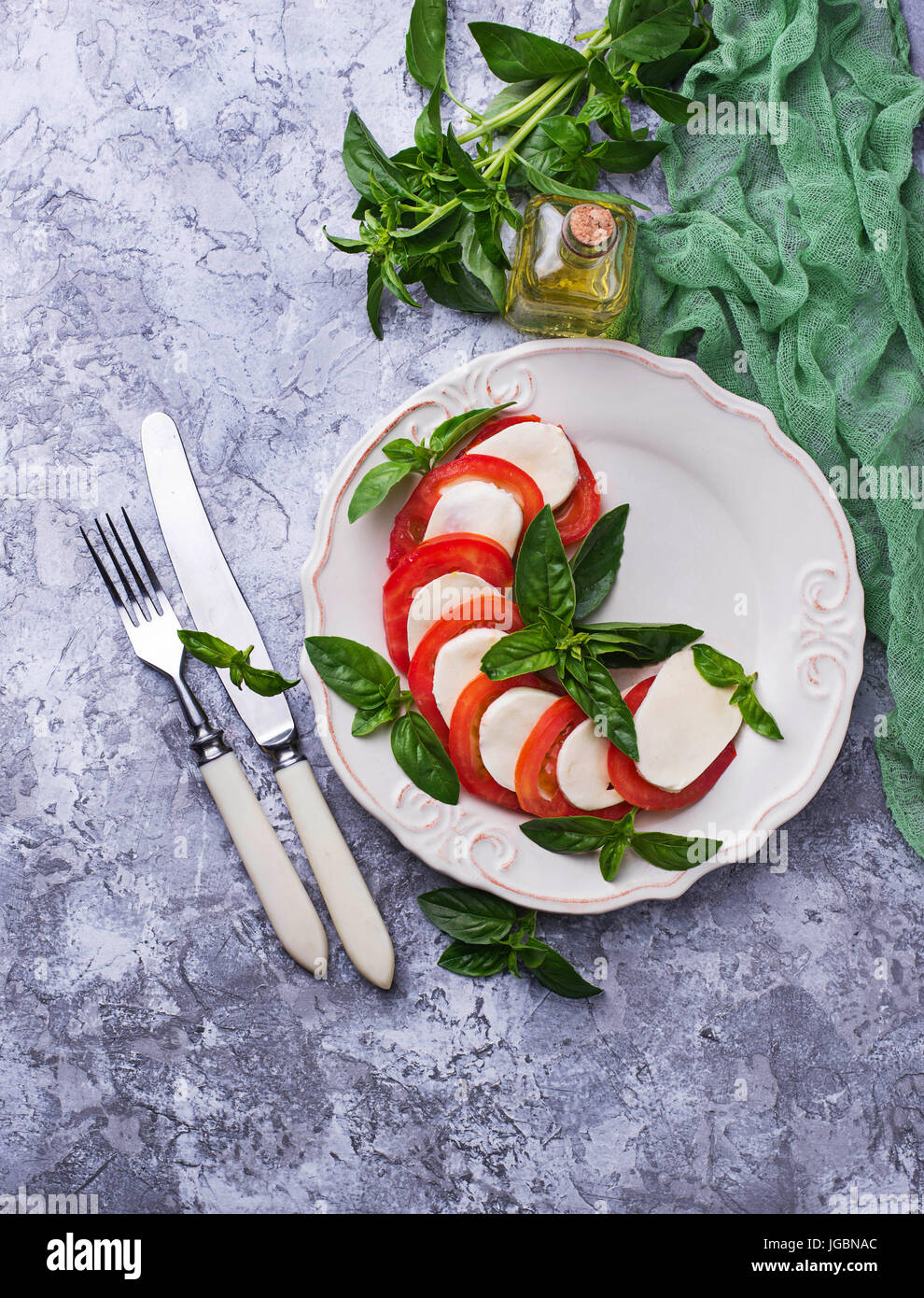 Italian caprese salad with mozzarella, tomatoes and basil. Top view ...