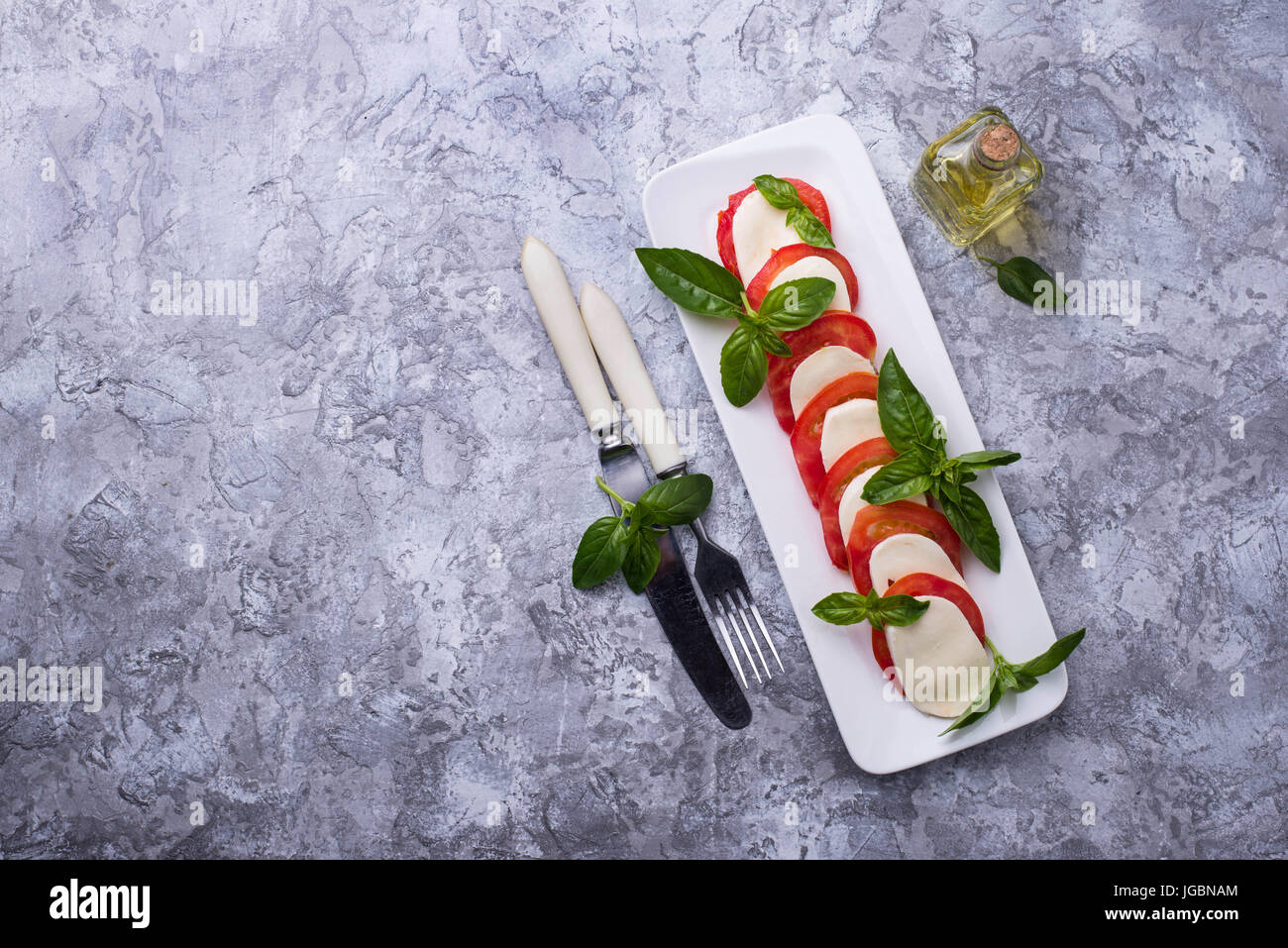 Italian caprese salad with mozzarella, tomatoes and basil. Top view ...