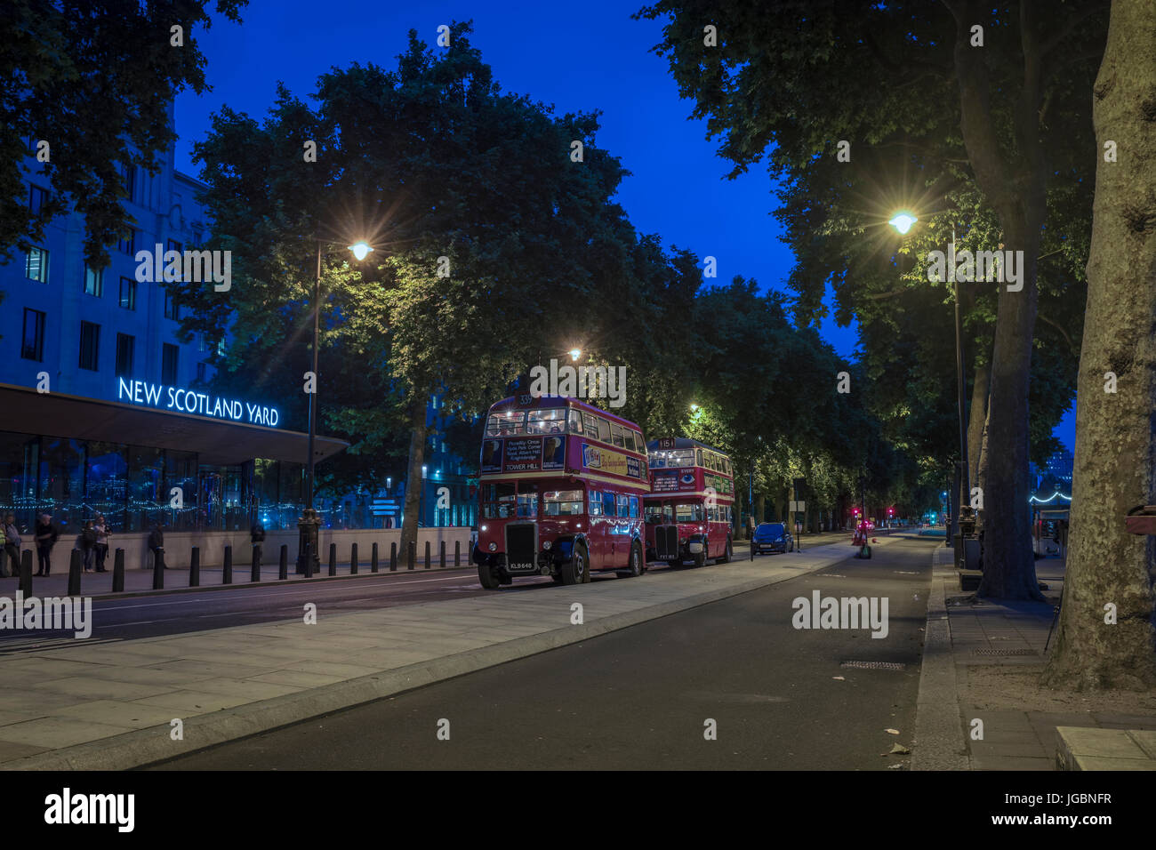 London vintage red buses at night outside New Scotland Yard Stock Photo ...