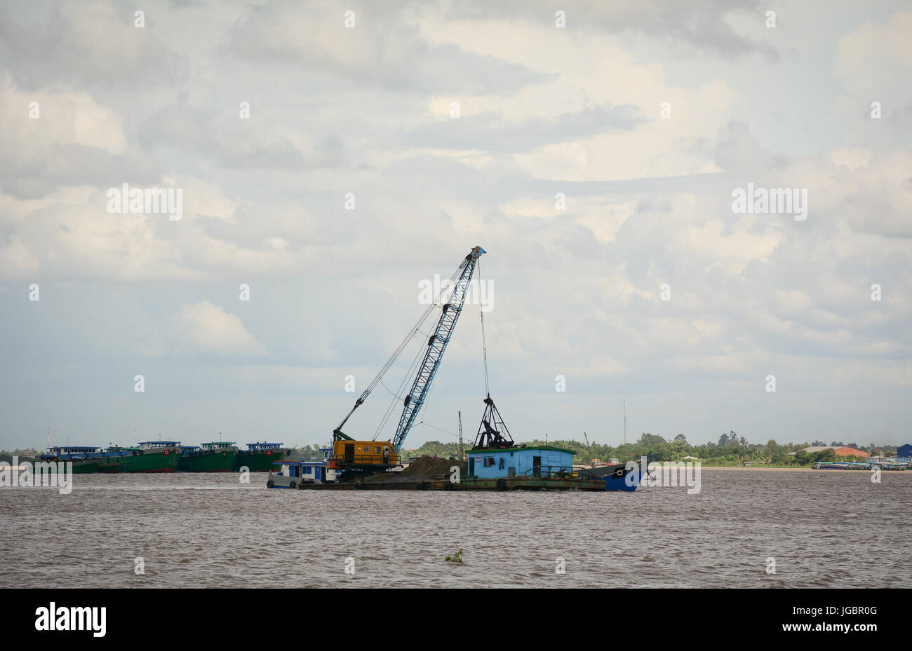 Landscape of Mekong River in Southern Vietnam. A cargo boat carrying ...