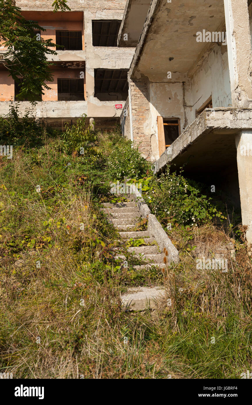 Burnt out buildings peppered with bullet holes are still commonly seen ...