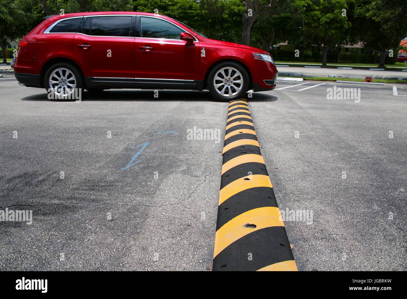Red Minivan Driving Up to and Just Connecting with Yellow and Black ...