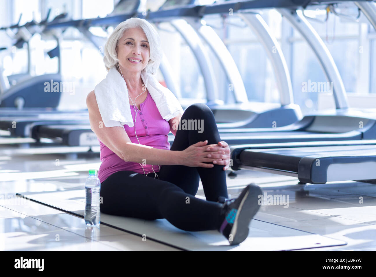 Senior lady having pause at gym Stock Photo - Alamy