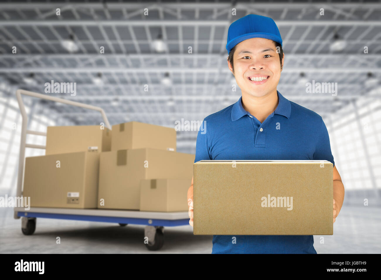 asian delivery man in distribution warehouse Stock Photo - Alamy