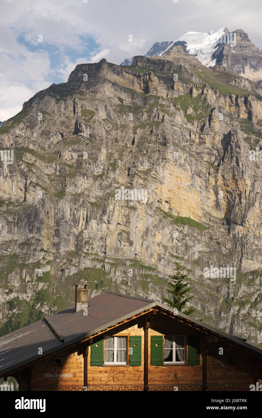 a mountain chalet and the Monch glacier in the background, Murren ...