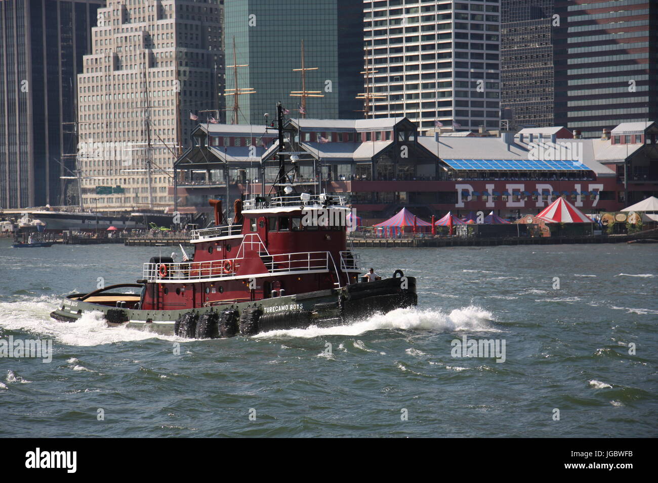 Tugboat passing Pier 17 Stock Photo - Alamy