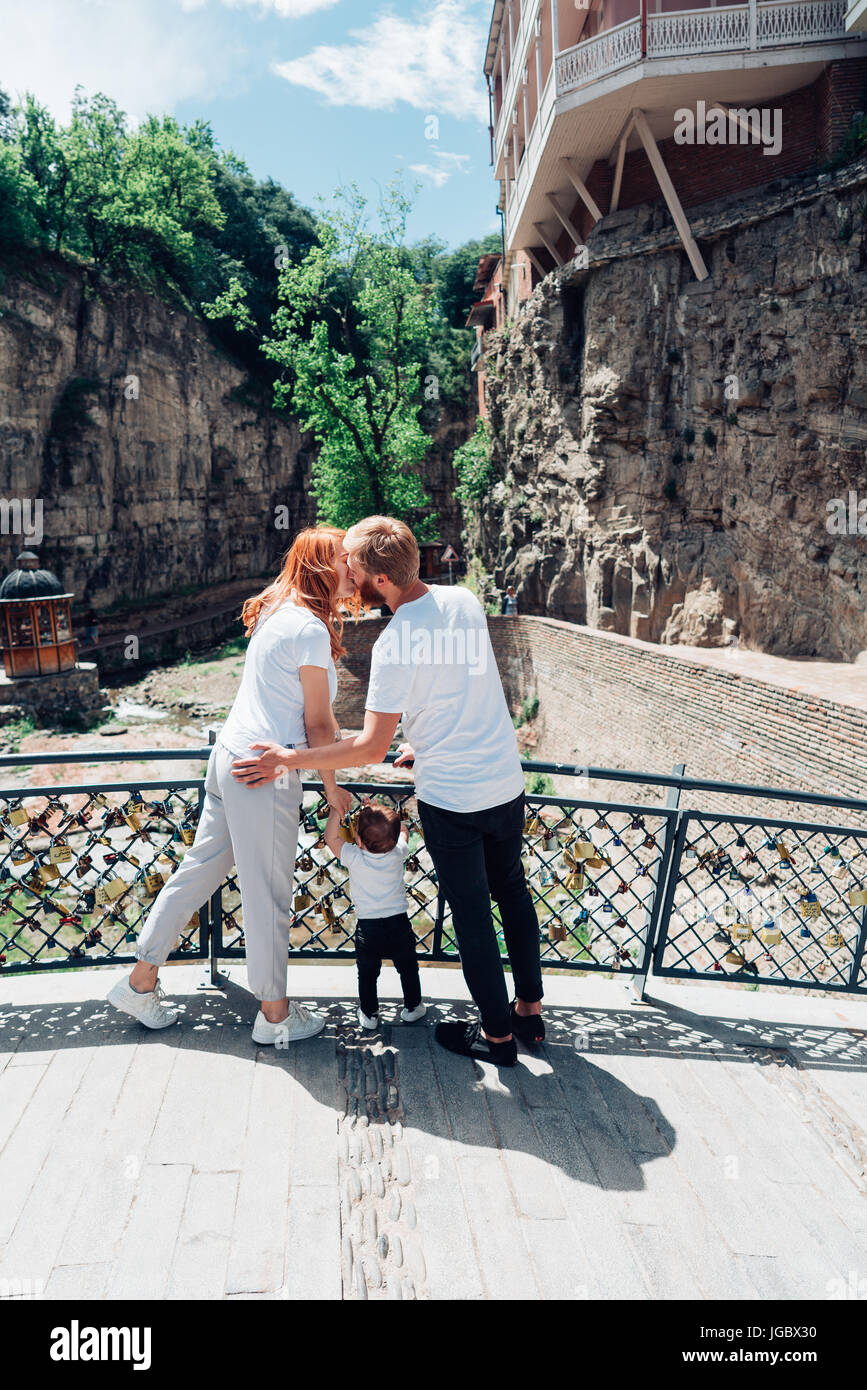 The family standing on bridge Stock Photo - Alamy