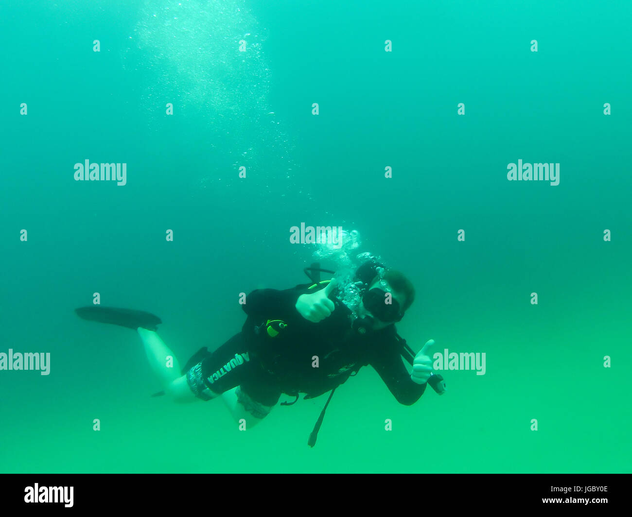 Scuba divers in the depths of the Mediterranean sea just outside of ...