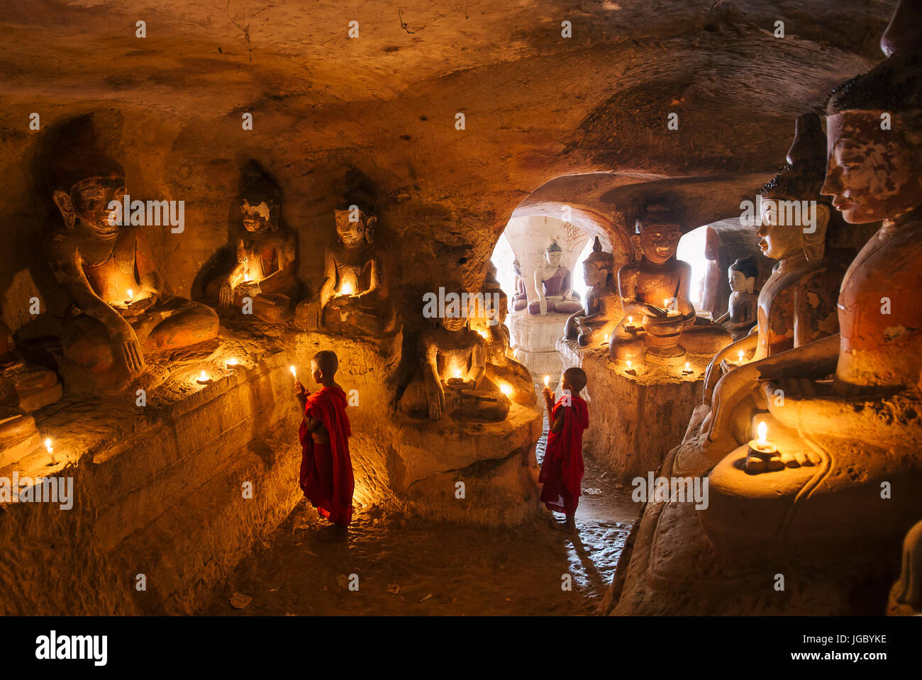 Buddhist novice monk praying inside Po Win Taung cave in Northern ...