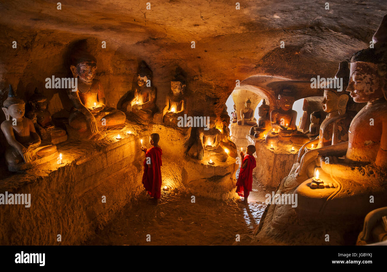 Buddhist novice monk praying inside Po Win Taung cave in Northern ...