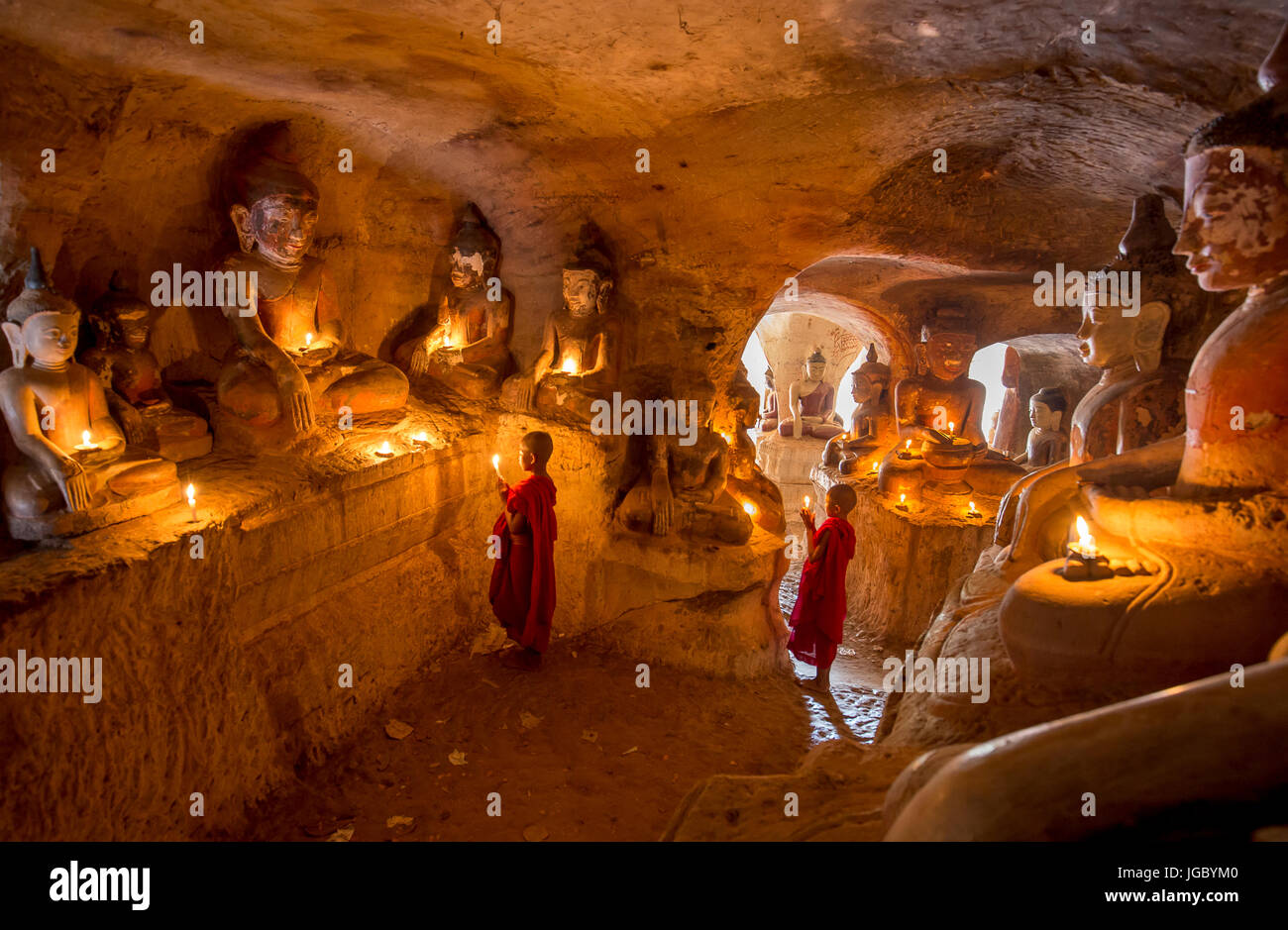 Buddhist novice monk praying inside Po Win Taung cave in Northern ...