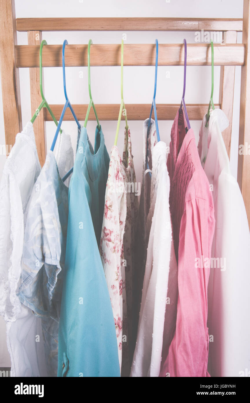 Different color clothes t-shirts on the rack Stock Photo - Alamy