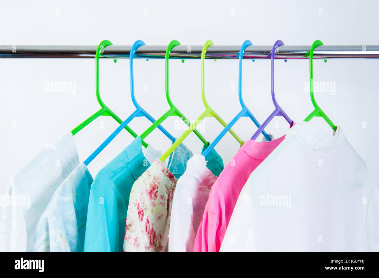 Different color clothes t-shirts on the rack Stock Photo - Alamy