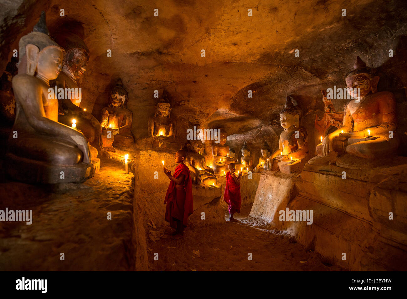 Buddhist novice monk praying inside Po Win Taung cave in Northern ...