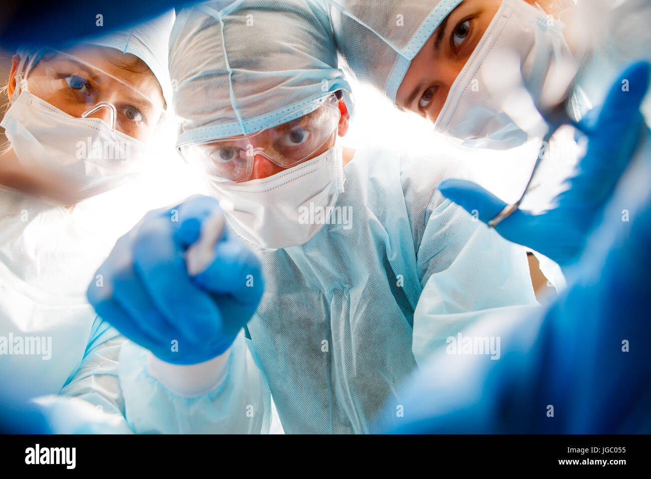 Young surgery team in masks at operating room Stock Photo - Alamy