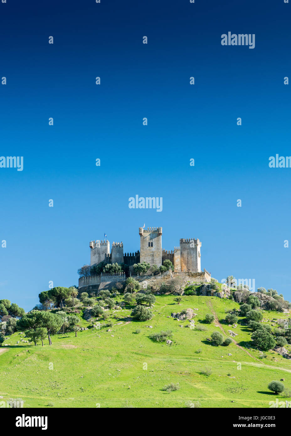 Ancient Roman castle on green hill against a deep blue cloudless sky ...