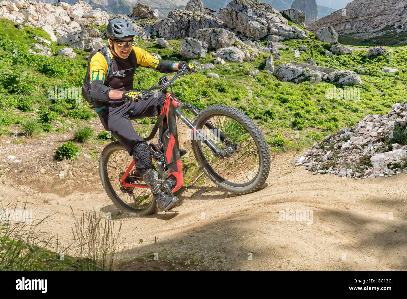 E bike rider in middle age enjoys the power of the e bike on a steep ...