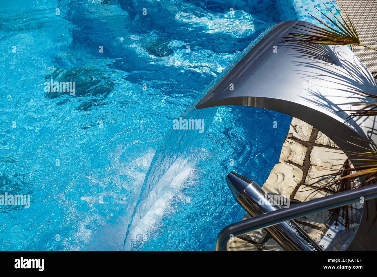 Swimming pool with fountain at hotel close up Stock Photo - Alamy